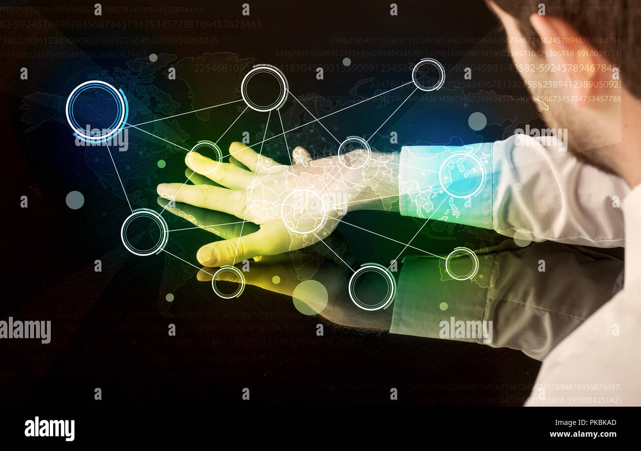 Male hands touching interactive table with colorful world map on it ...