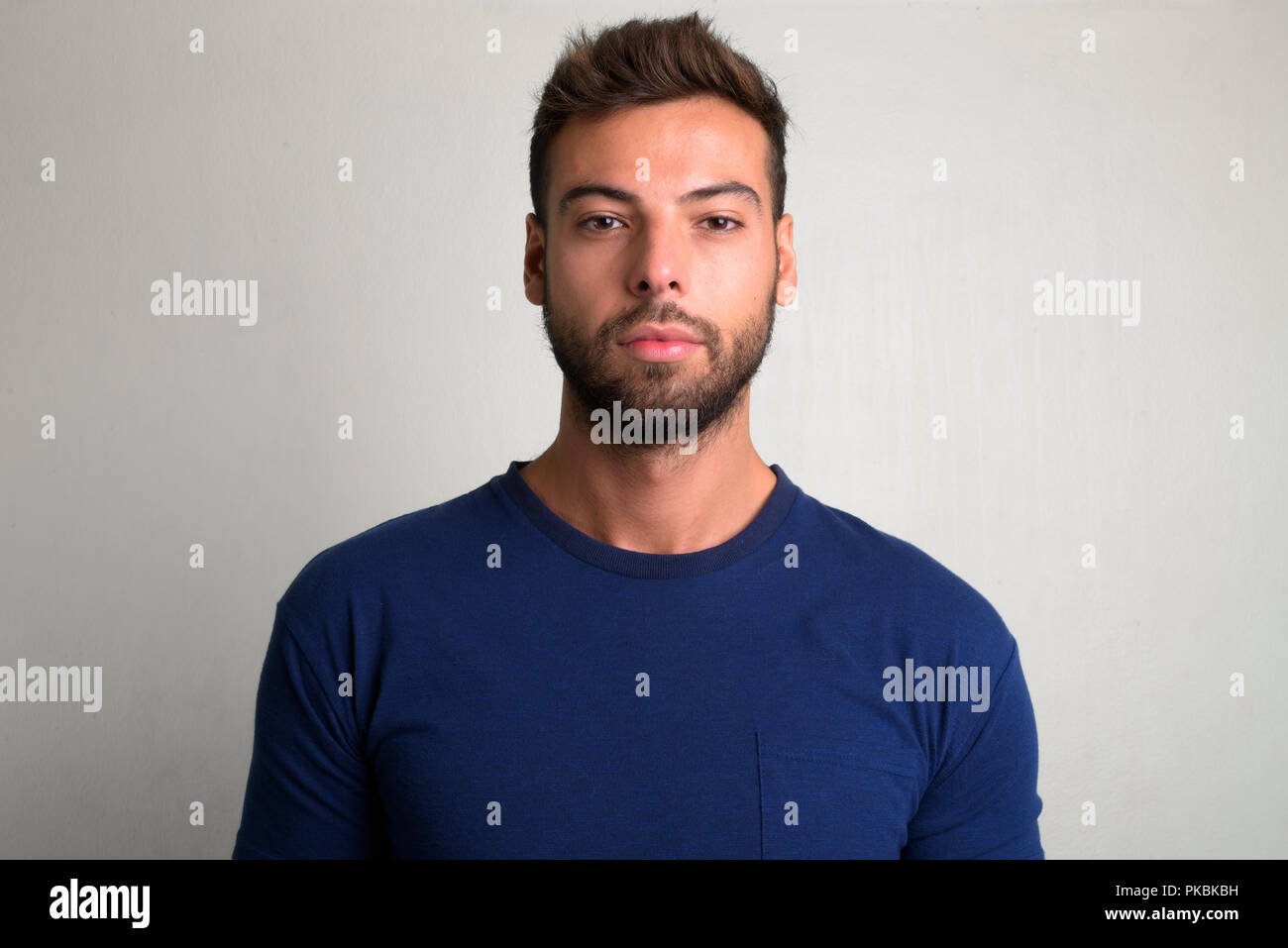 Studio shot of young handsome bearded man Stock Photo - Alamy