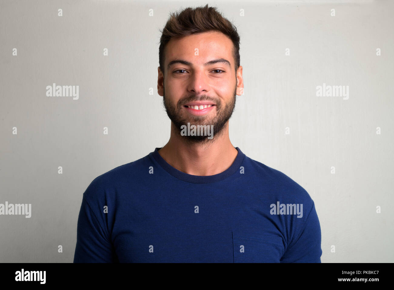 Studio shot of young handsome bearded man Stock Photo - Alamy