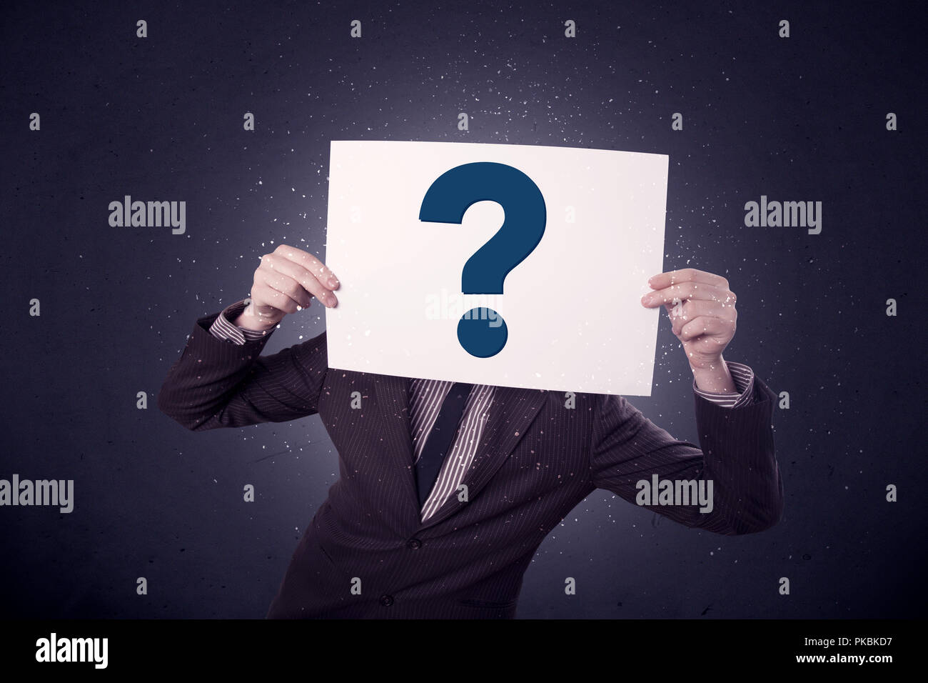 Young businessman hiding behind a question mark drawn on paper Stock ...