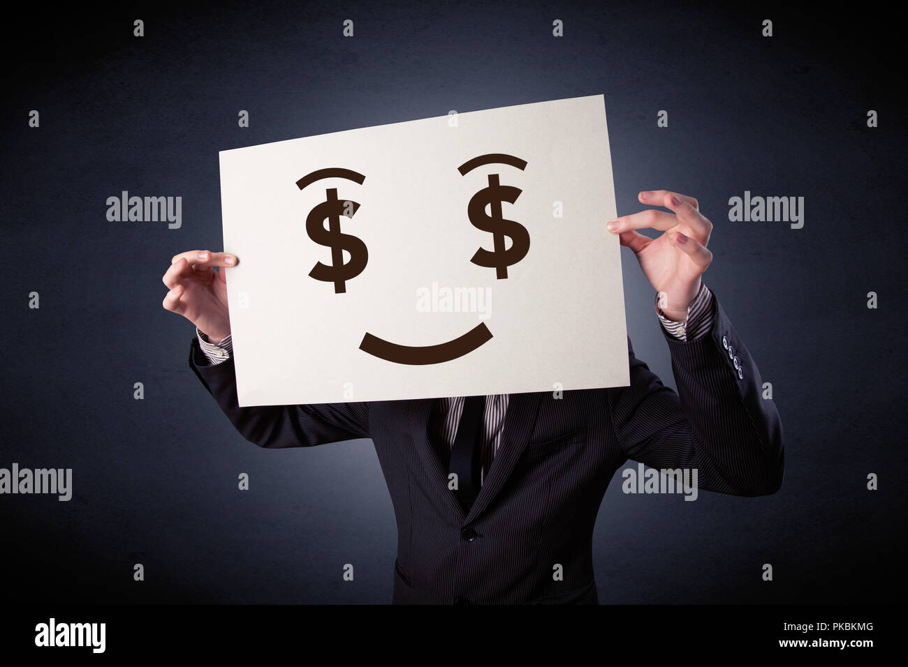 Young casual businessman hiding behind a greedy face drawing on ...