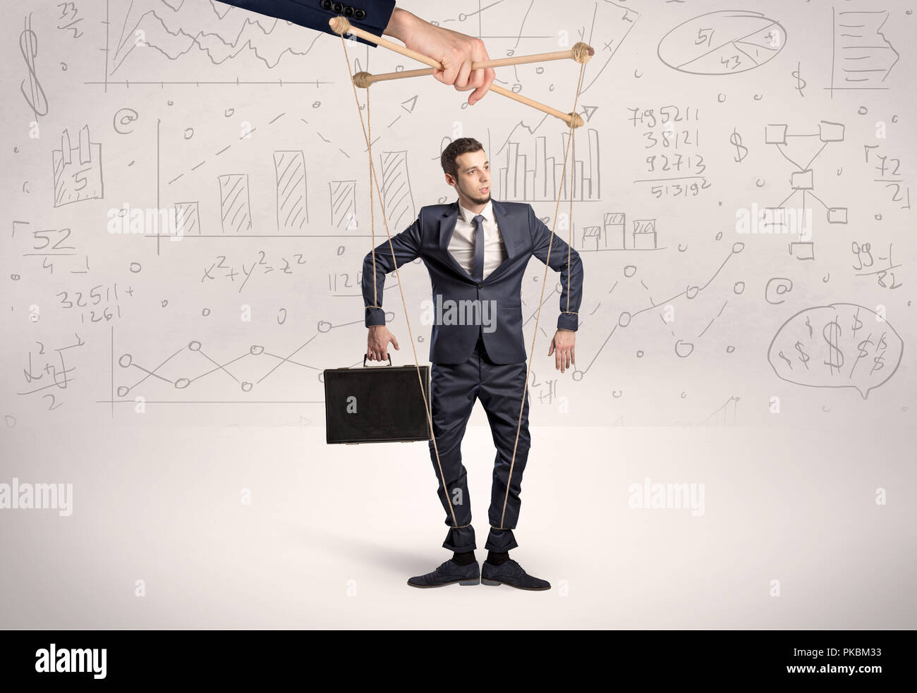 Puppet employee controlled by a big hand with documents and staffs ...