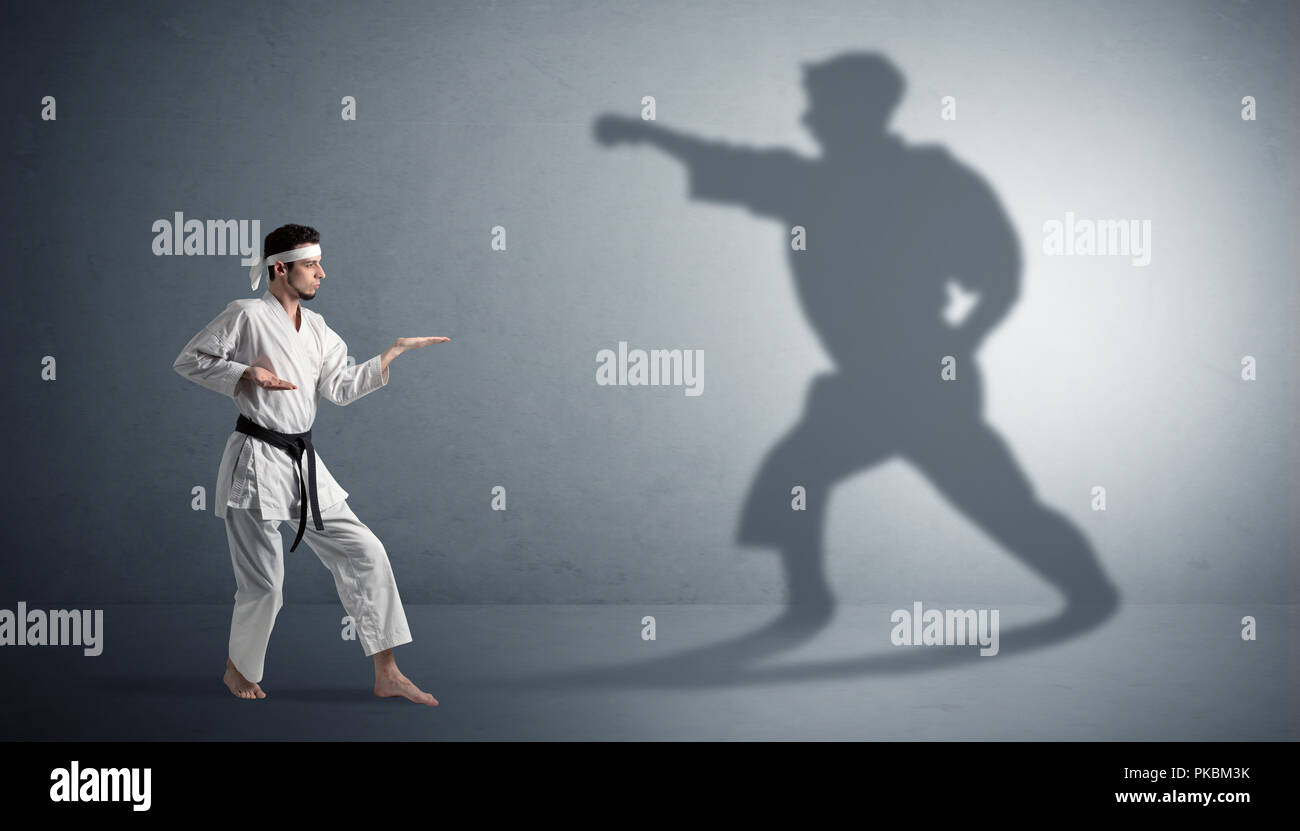 Young karate man confronting with his own shadow Stock Photo - Alamy