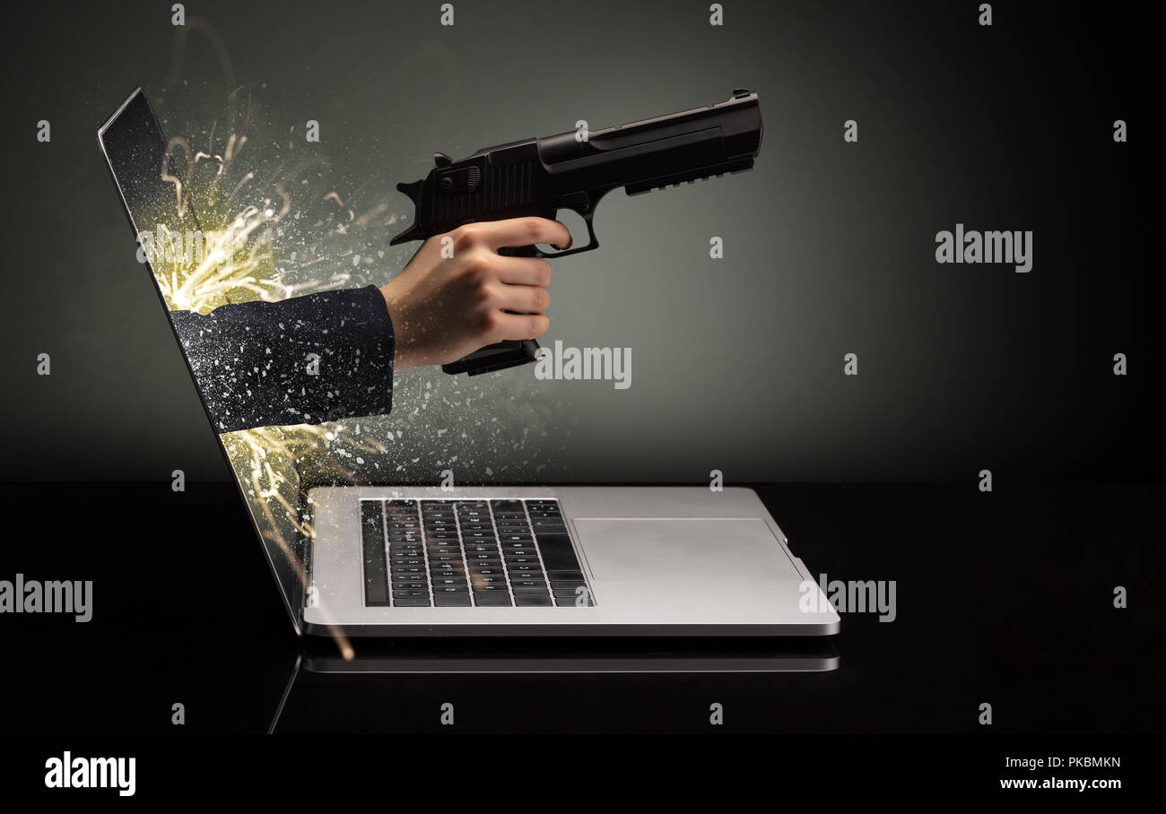 Hand with gun coming out of a laptop with sparkling effects Stock Photo ...