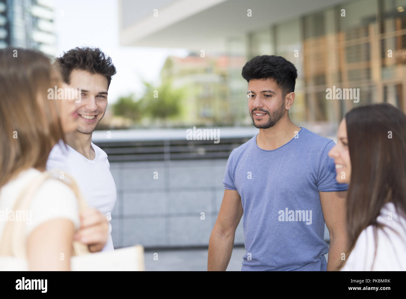 Group of young friends speaking outdoor Stock Photo - Alamy