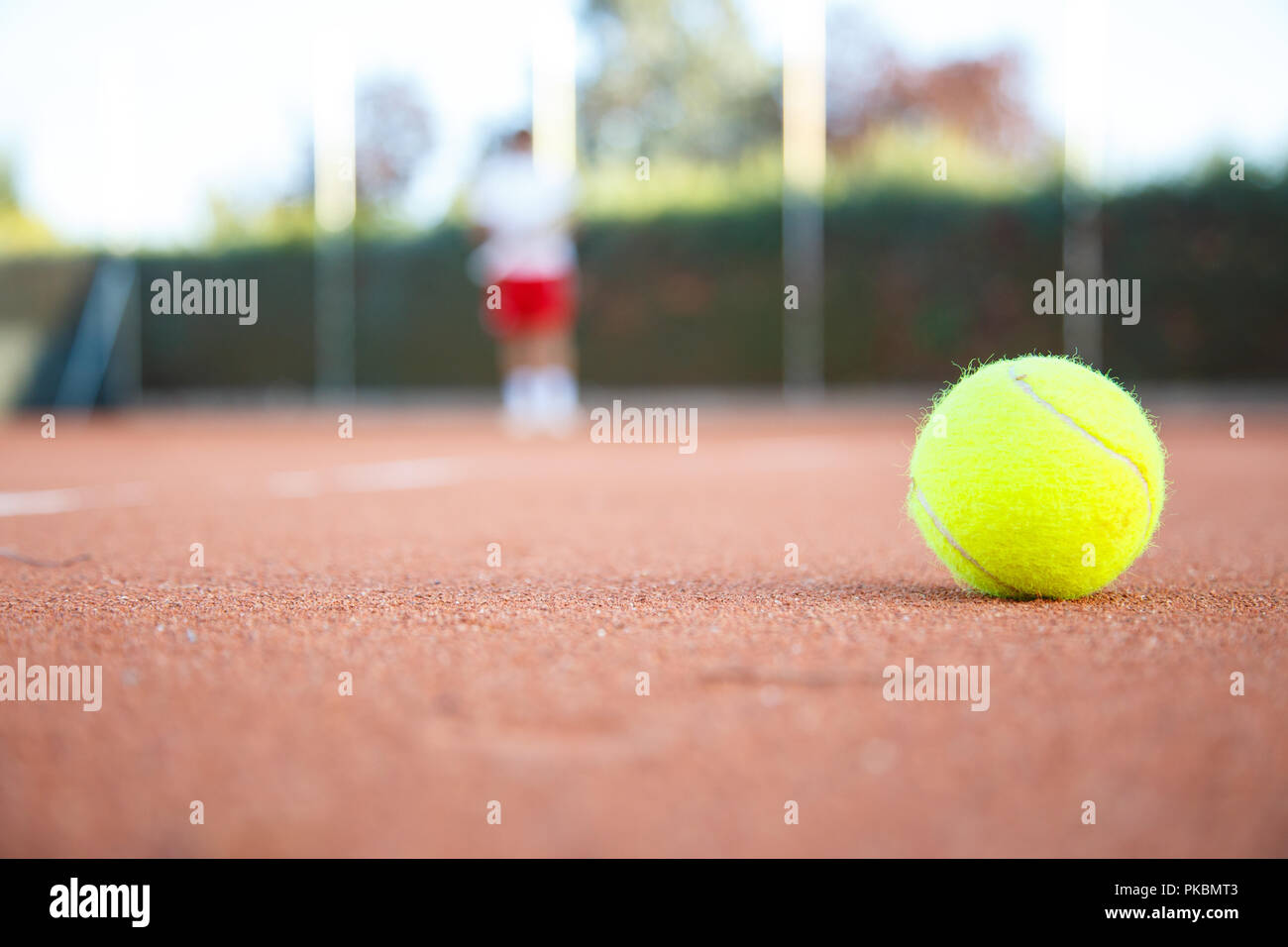 Tennis ball on the floor of a tennis court in a match in the shade ...