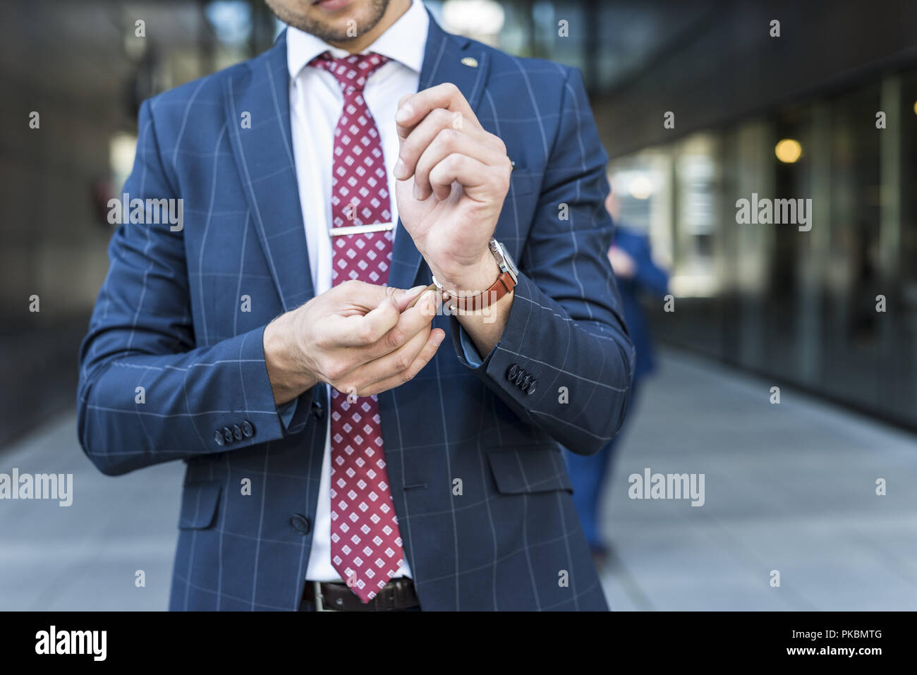 Businessman adjusting watch hi-res stock photography and images - Alamy