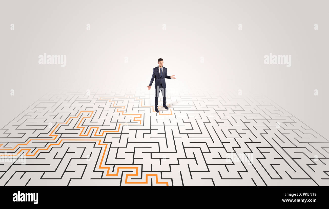Young entrepreneur standing in a middle of a labyrinth with the ...