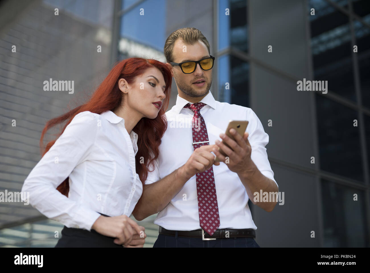Business people using a smartphone Stock Photo - Alamy