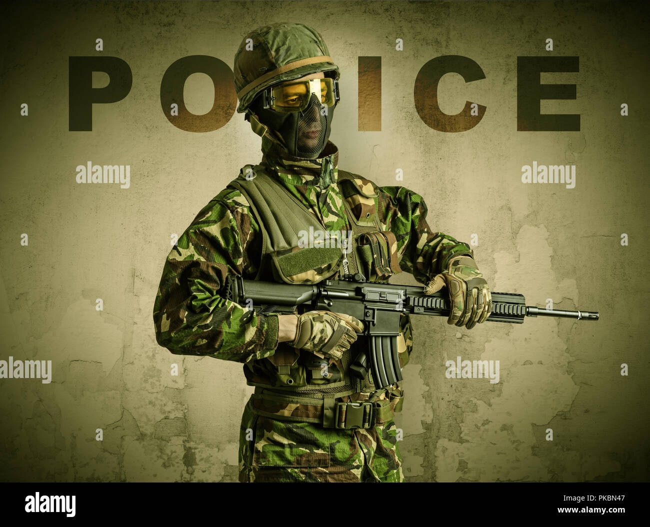 Uniformed armed soldier with damaged wall background Stock Photo - Alamy