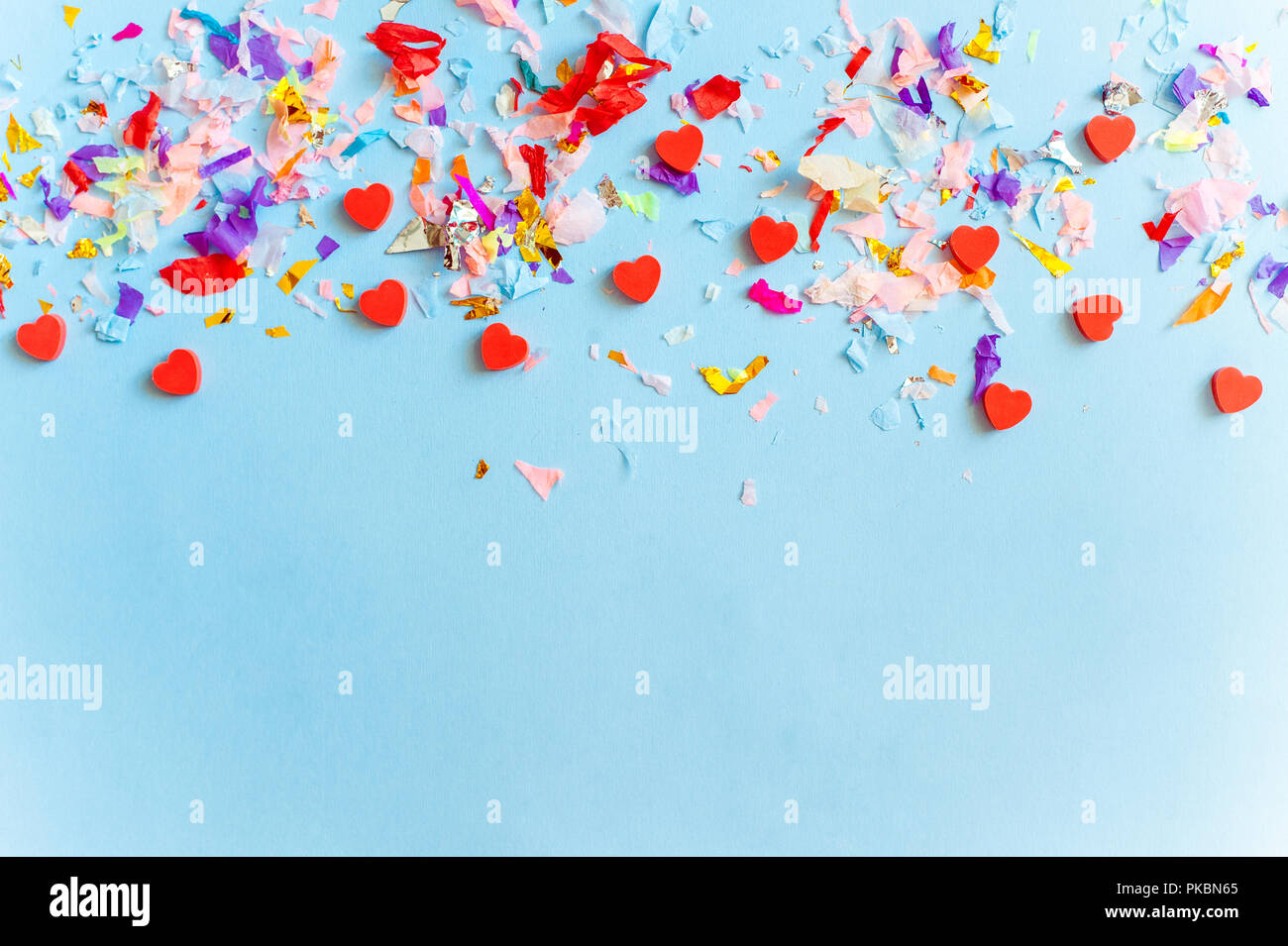 Blue paper with bright confetti. Copy space Stock Photo - Alamy