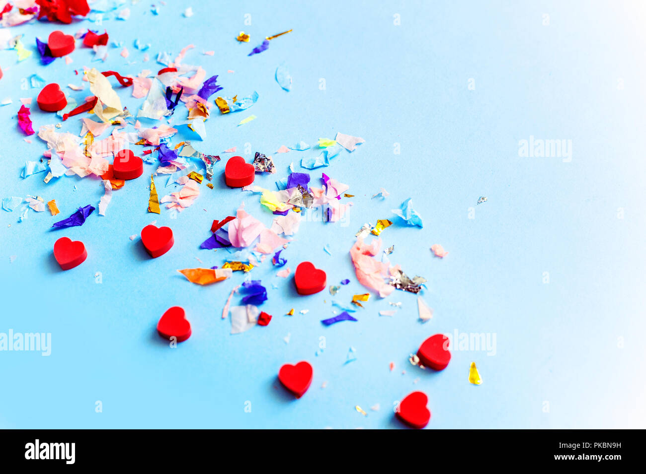 Blue paper with bright confetti. Copy space Stock Photo - Alamy