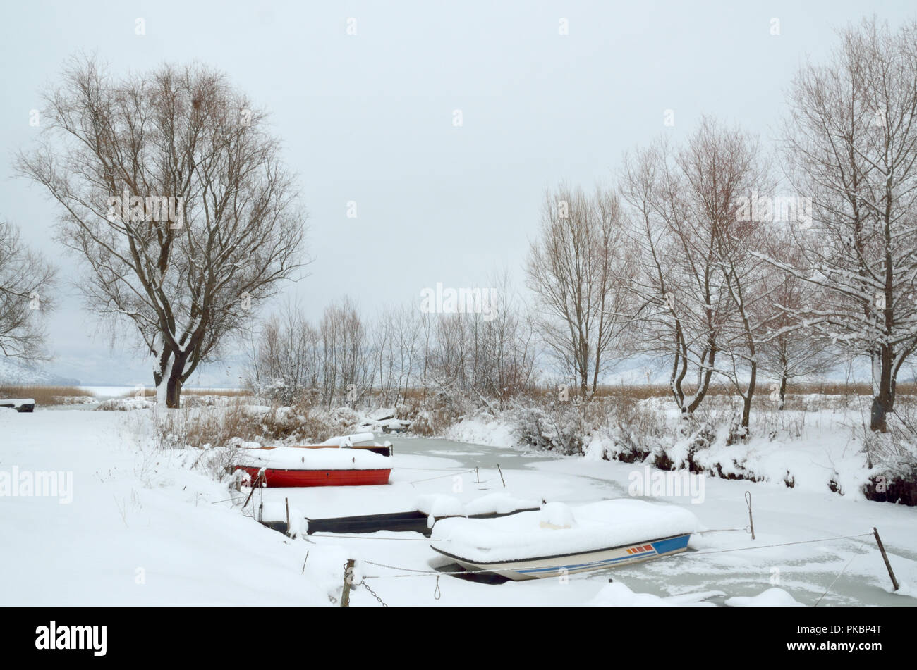 Small fishing boats covered with snow Stock Photo - Alamy