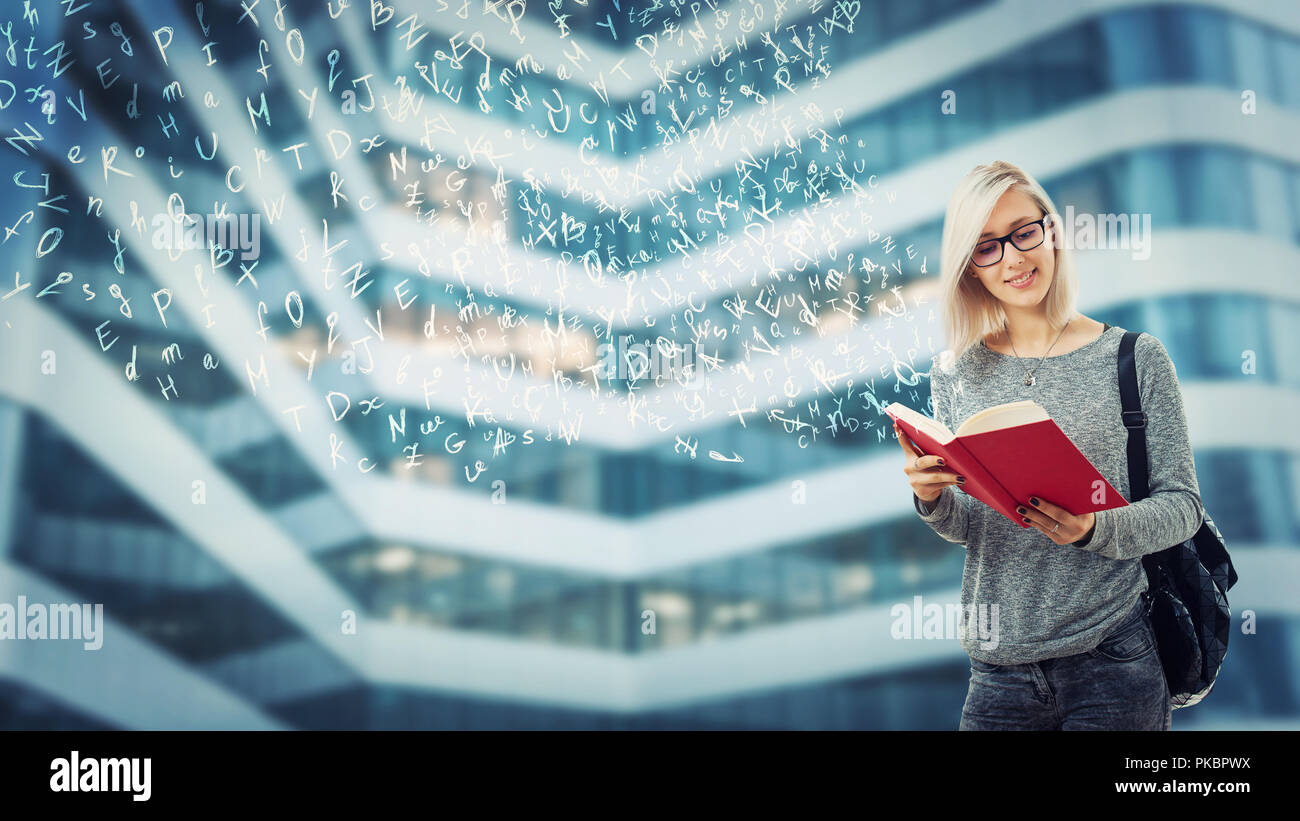 Young student female with a backpack and glasses reading a book imagine ...