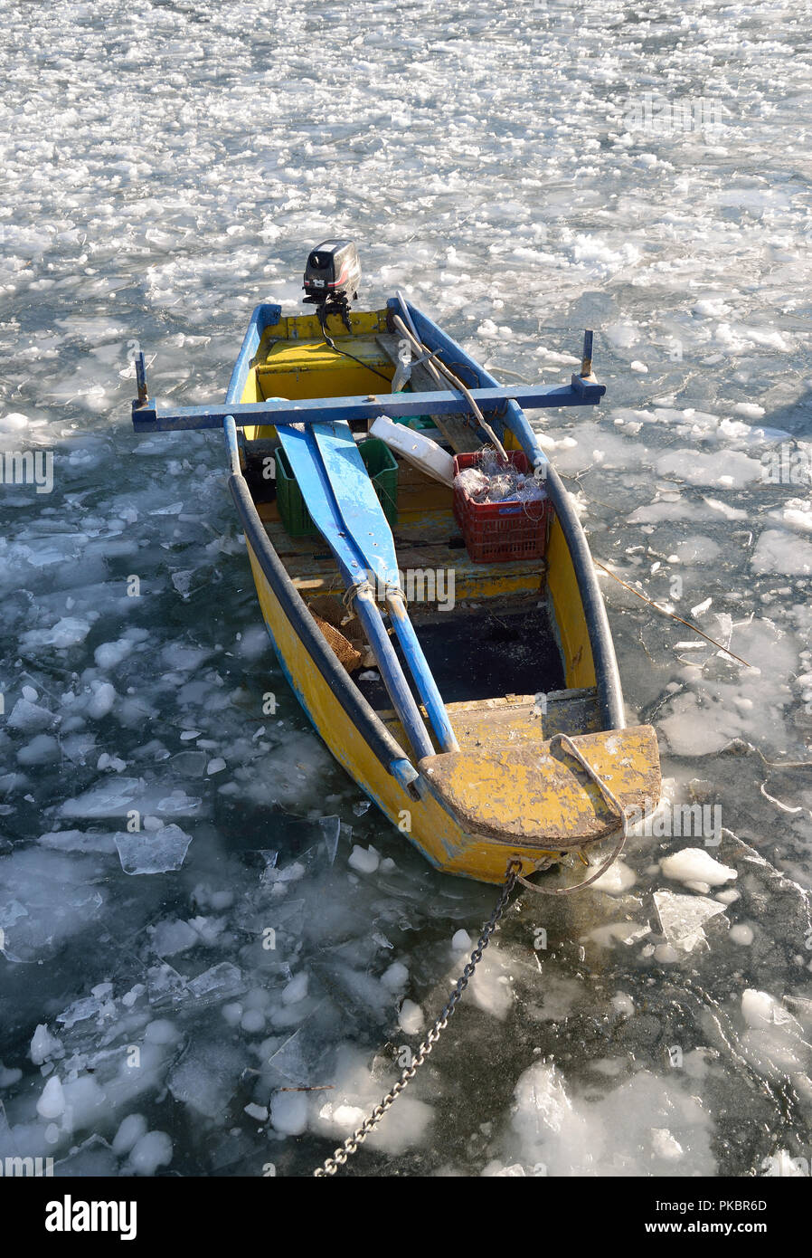 Fishing boat trapped in ice lake Stock Photo - Alamy