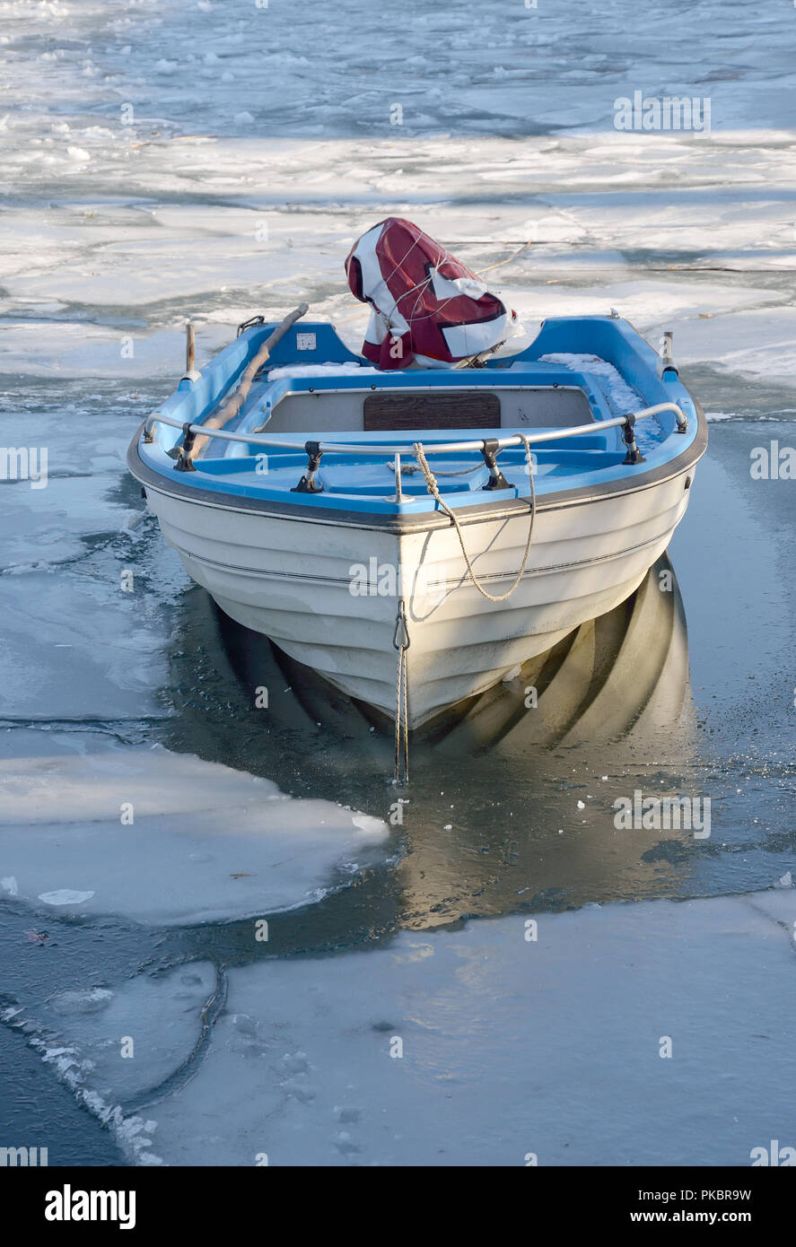 Boat in icy surface of lake Stock Photo - Alamy