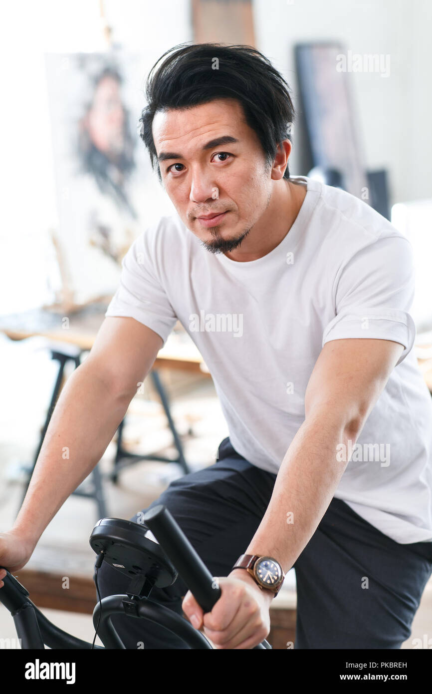 Riding a bicycle fitness male artists Stock Photo - Alamy