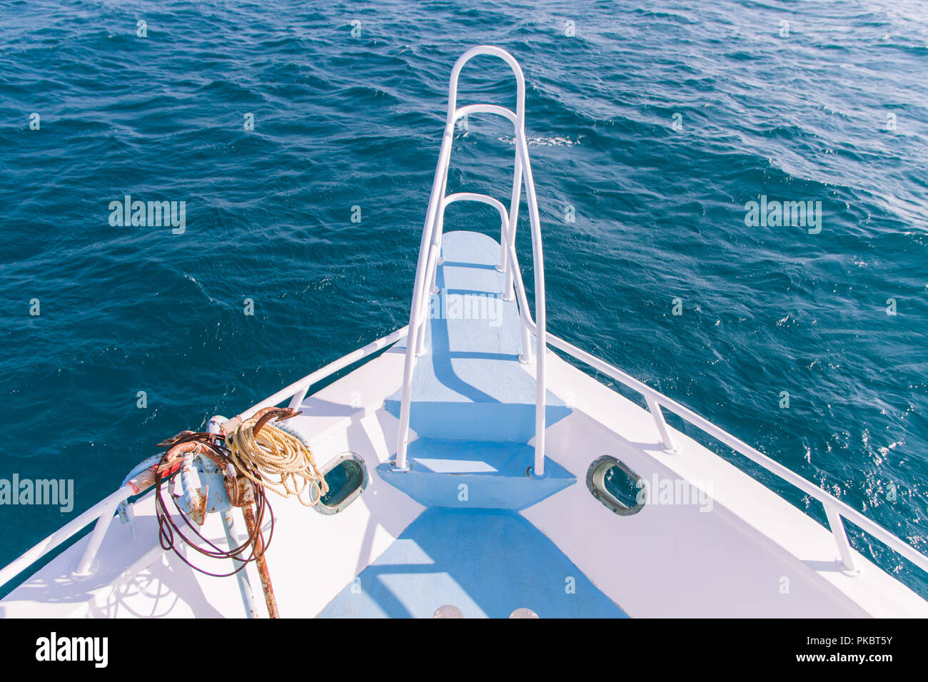 White and Blue Boat Bow and Pullpit with Rusty Anchor and Blue Sea ...
