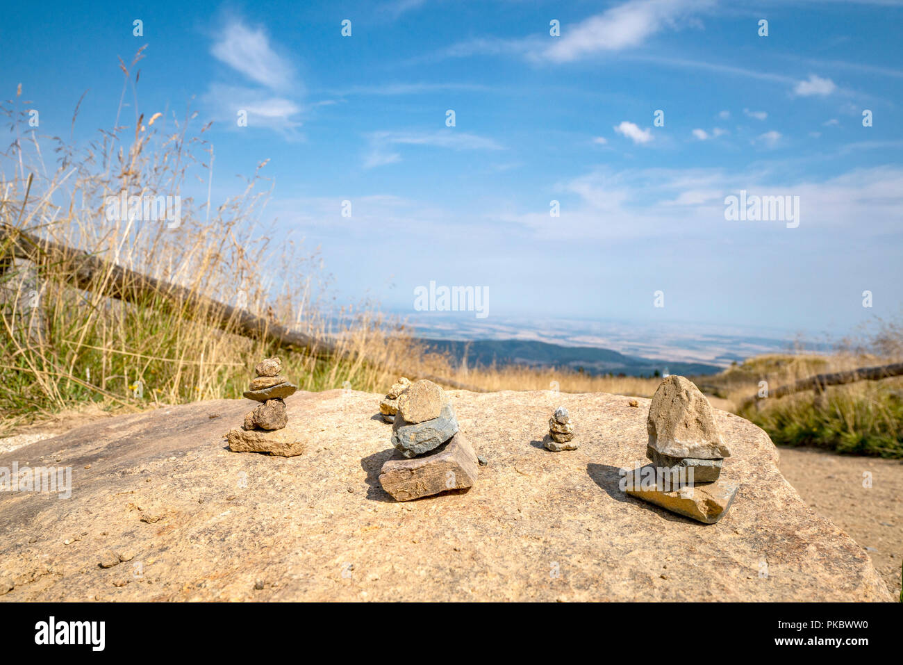 Small pebble stacks balancing on a large rock in harmony with the ...