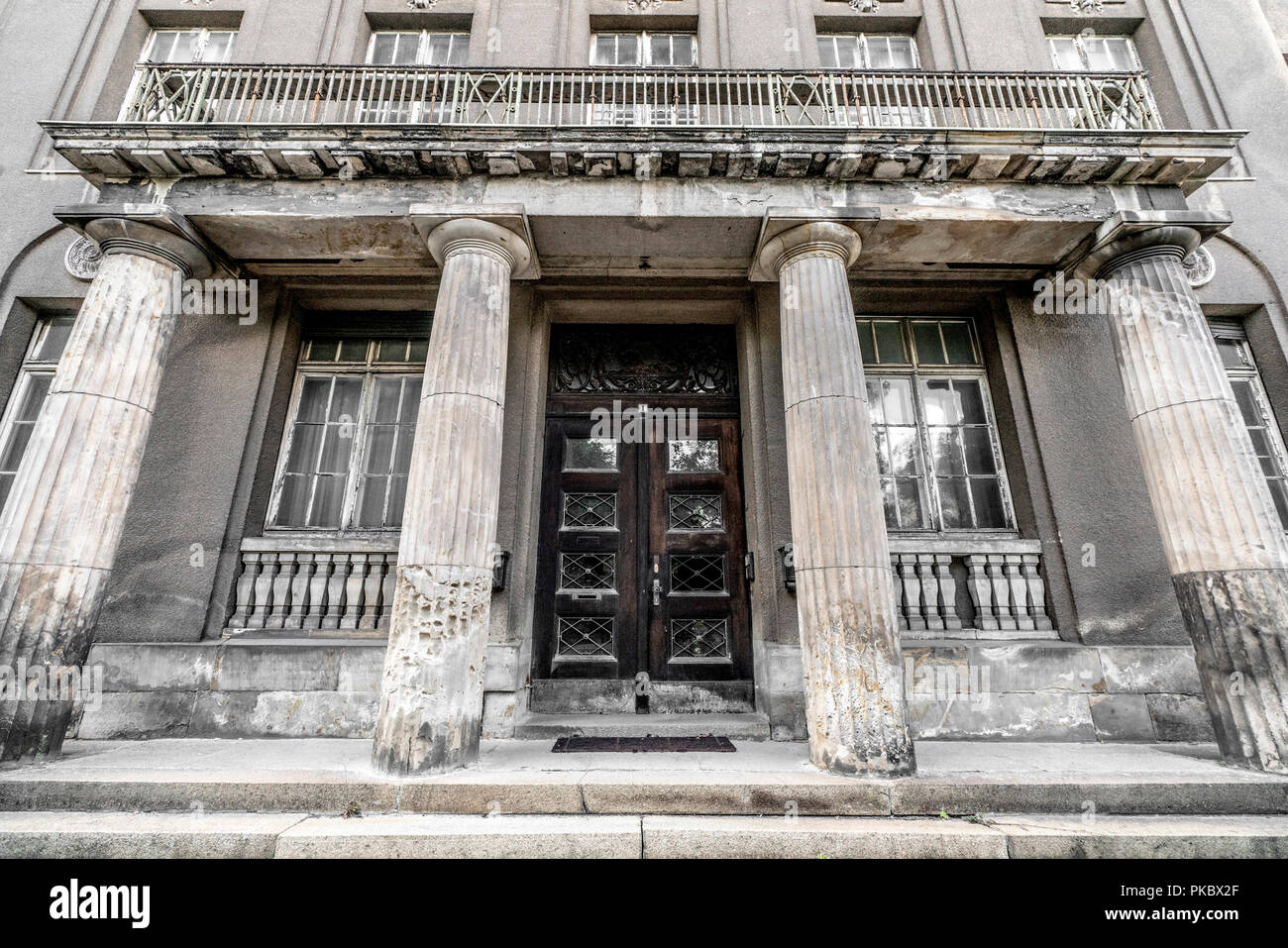 Greek pillar building with weathered windows and facade Stock Photo - Alamy