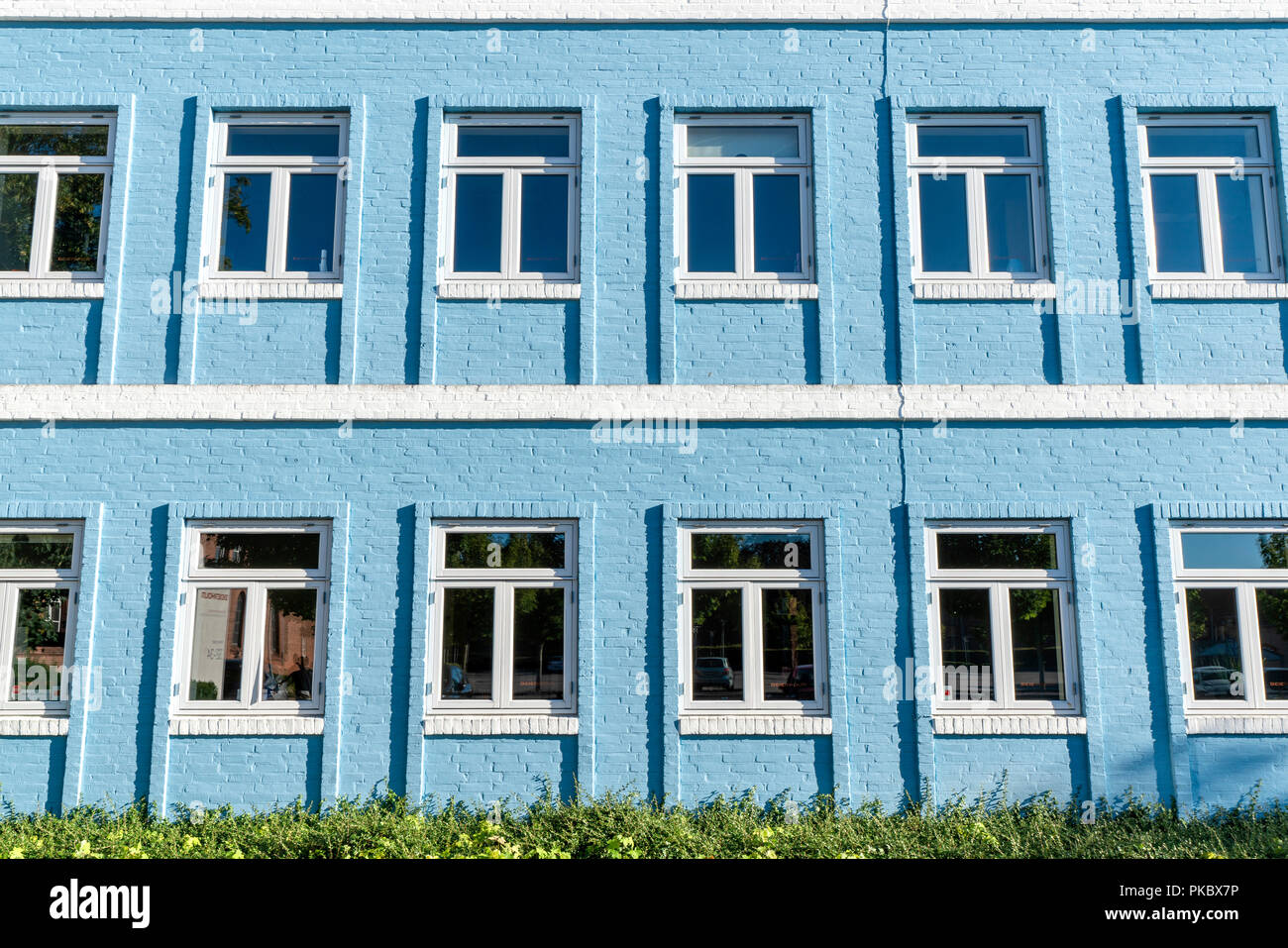 Blue brick house with white windows side by side Stock Photo - Alamy