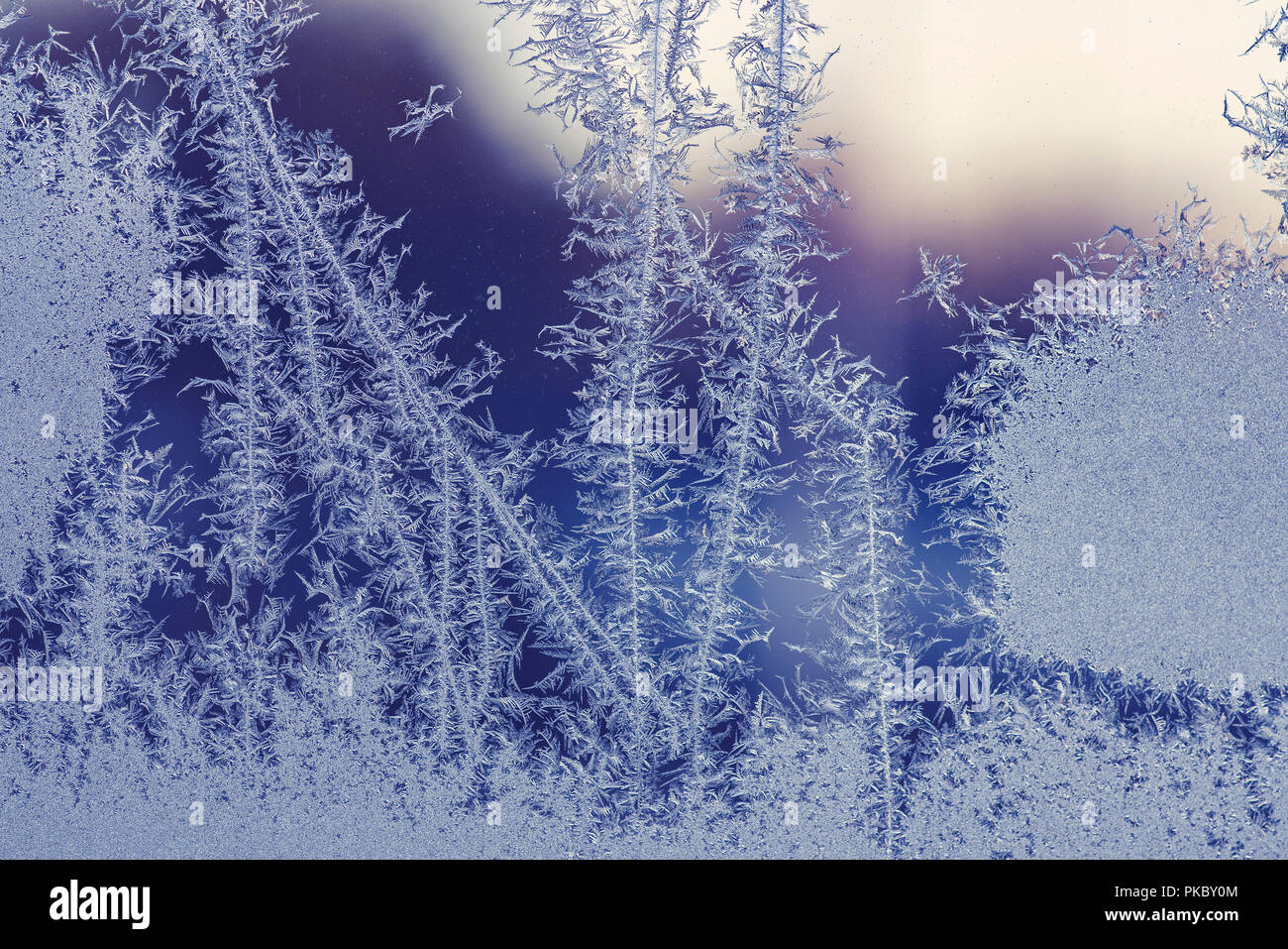 Hoarfrost on a window in the winter in beautiful snowflake patterns ...