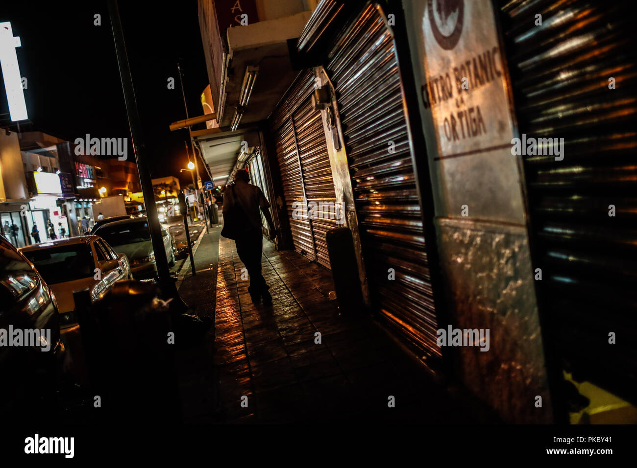 . A man walks on the sidewalk and dark streets. Daily life in the ...