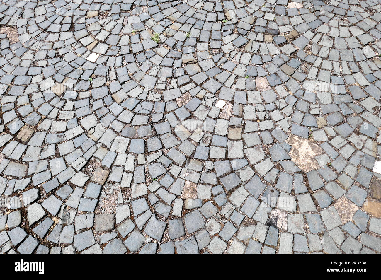 round urban pavement granite stones on a footpath. texture background ...