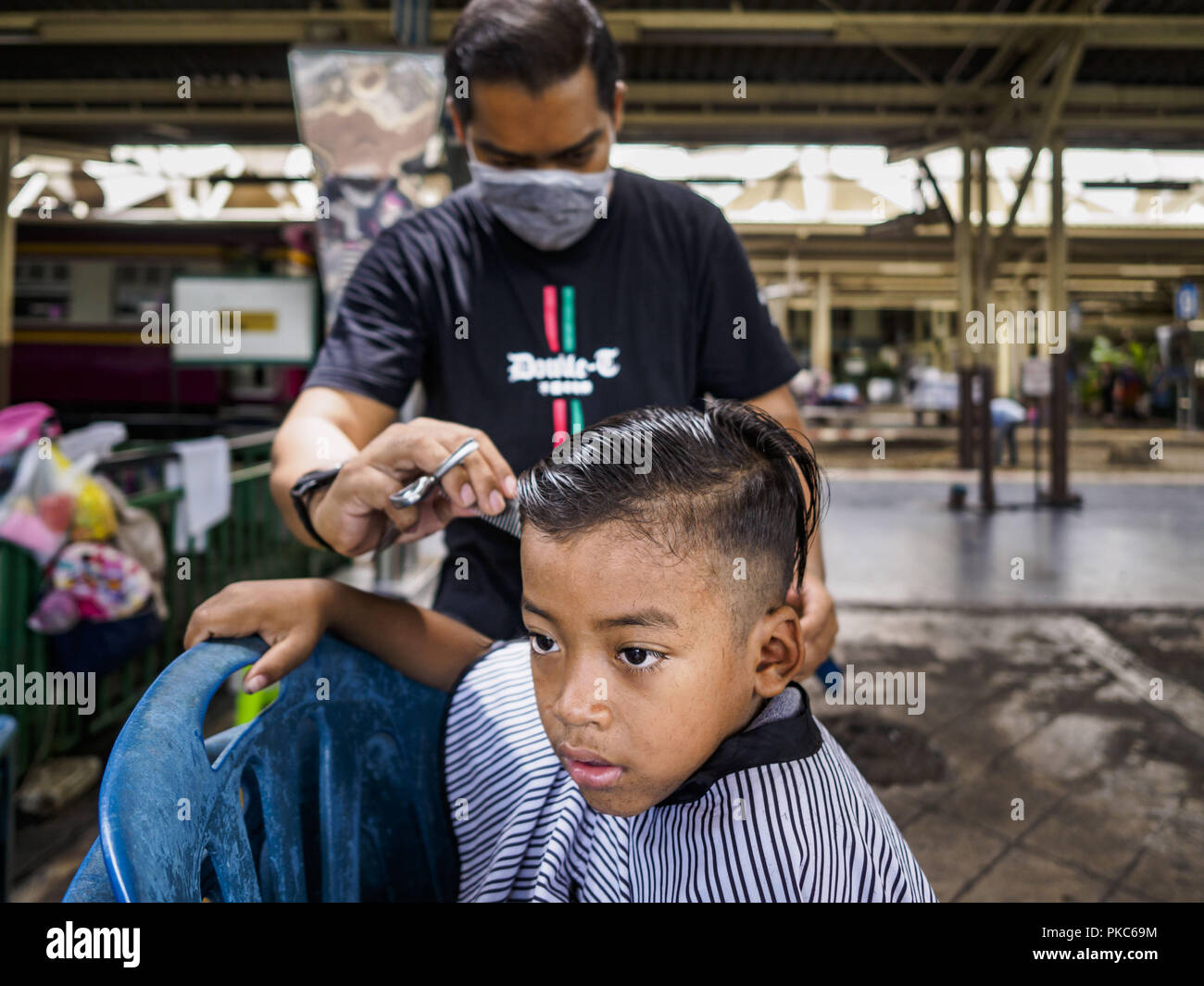 Bangkok, Bangkok, Thailand. 12th Sep, 2018. A barber gives a child a ...