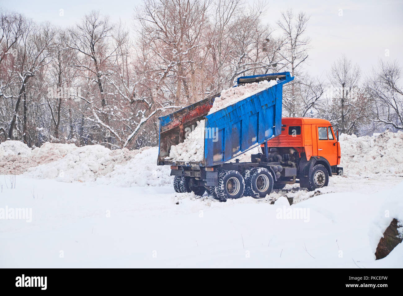 Cargo truck transporting snow pile. Wintern cleaning equipment Stock ...