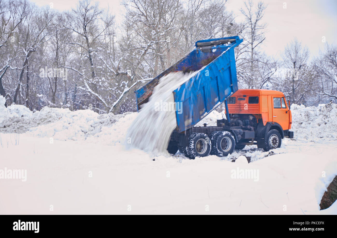 Cargo truck transporting snow pile. Wintern cleaning equipment Stock ...