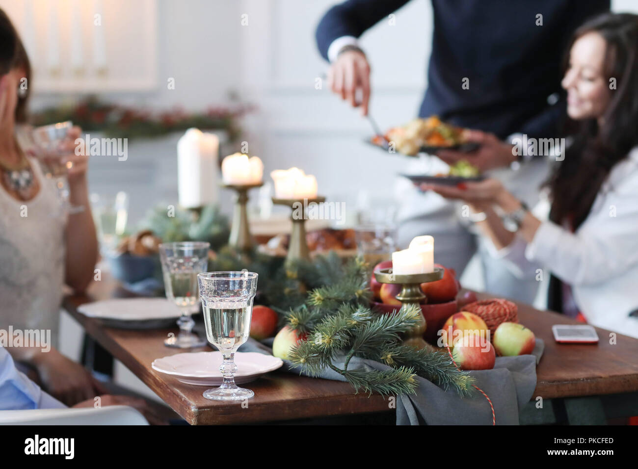 Christmas Day. Celebration dinner with group of friends Stock Photo - Alamy