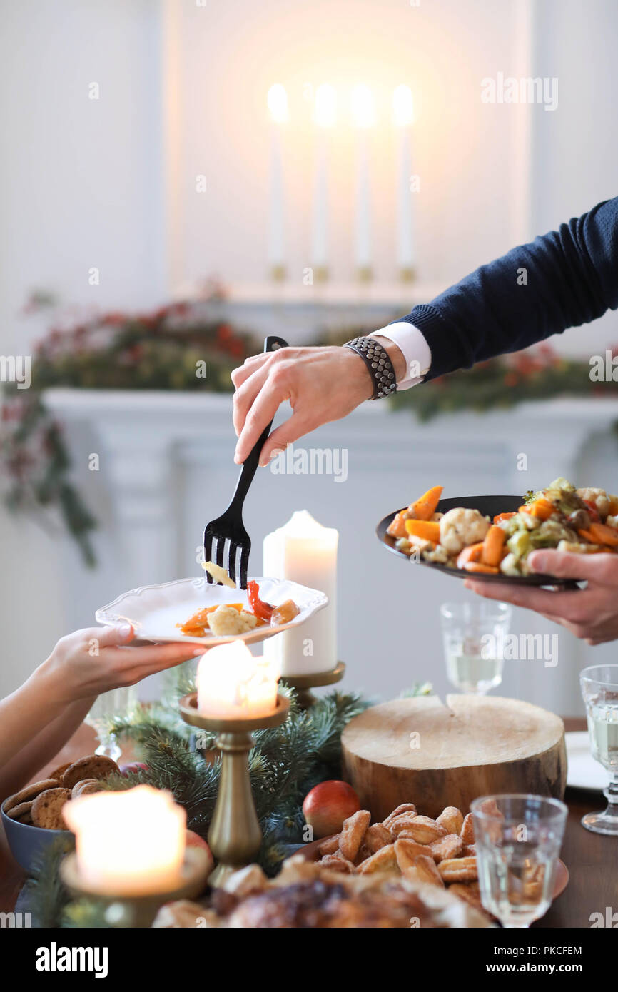 Christmas Day. Celebration dinner with group of friends Stock Photo - Alamy