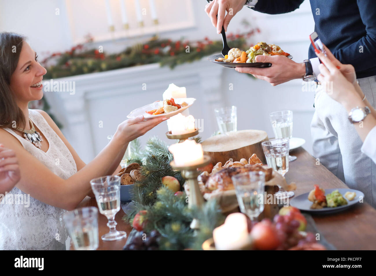 Christmas Day. Celebration dinner with group of friends Stock Photo - Alamy