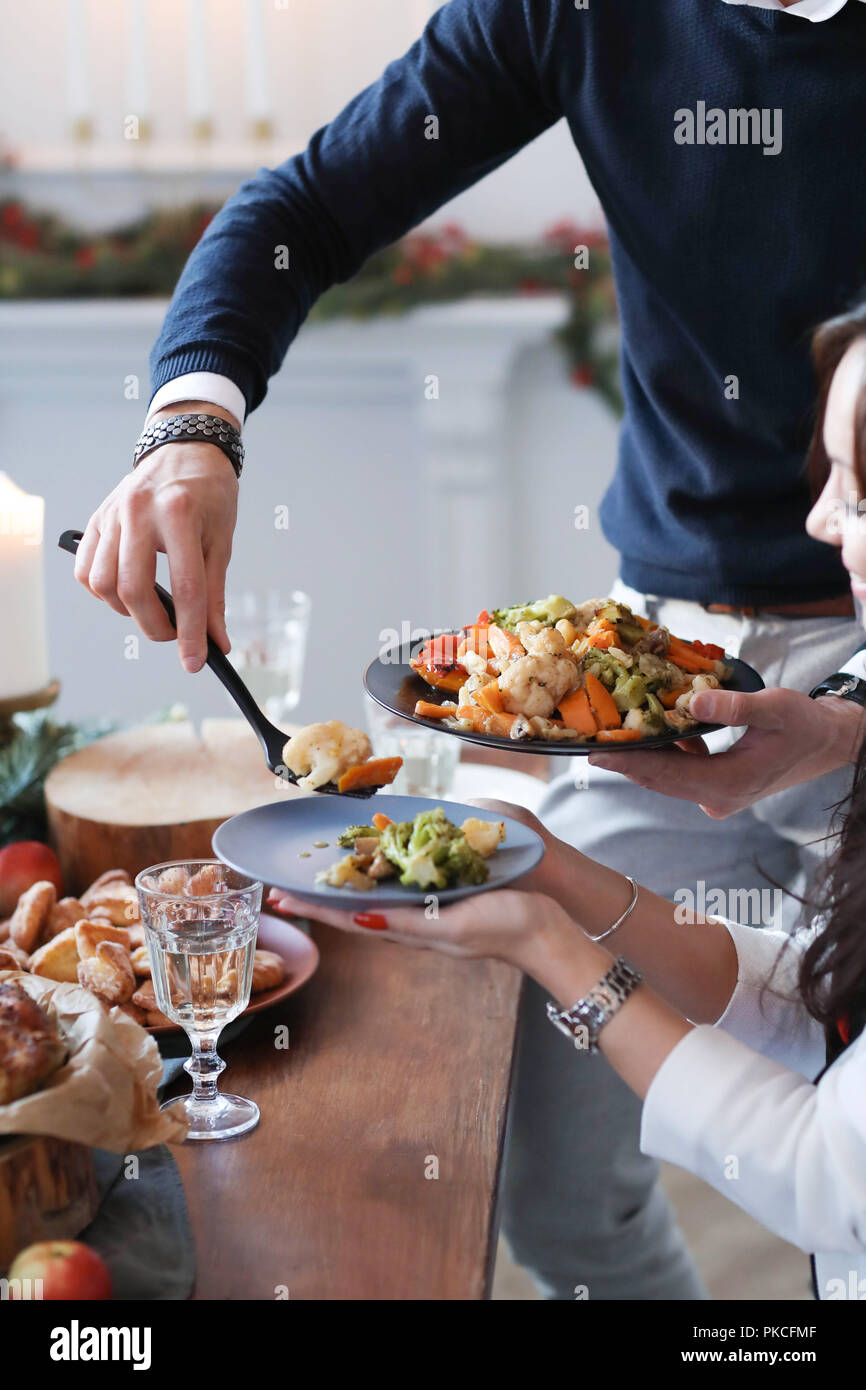Christmas Day. Celebration dinner with group of friends Stock Photo - Alamy