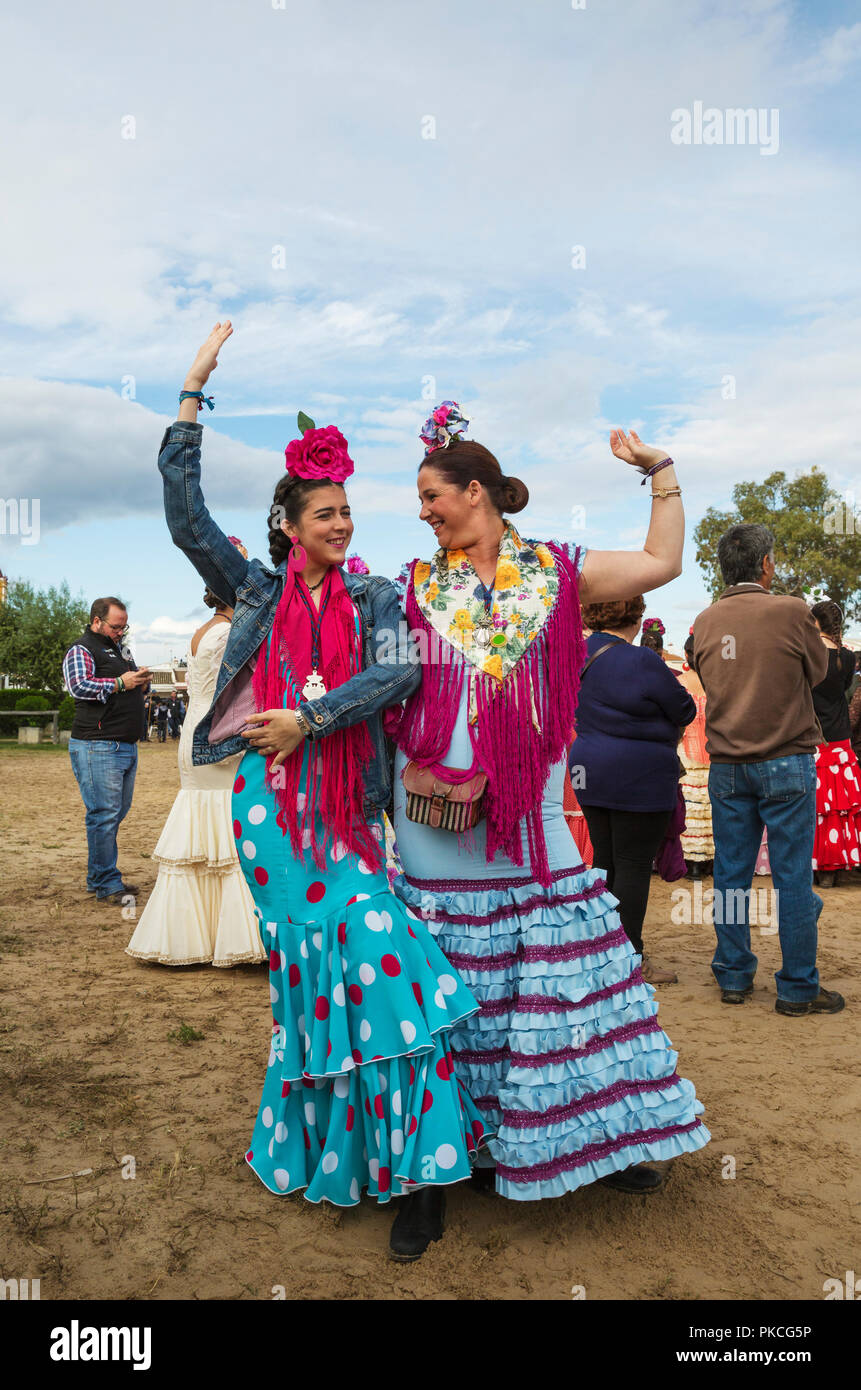Women wearing colourful gypsy dresses dance the Sevillana, Pentecost ...