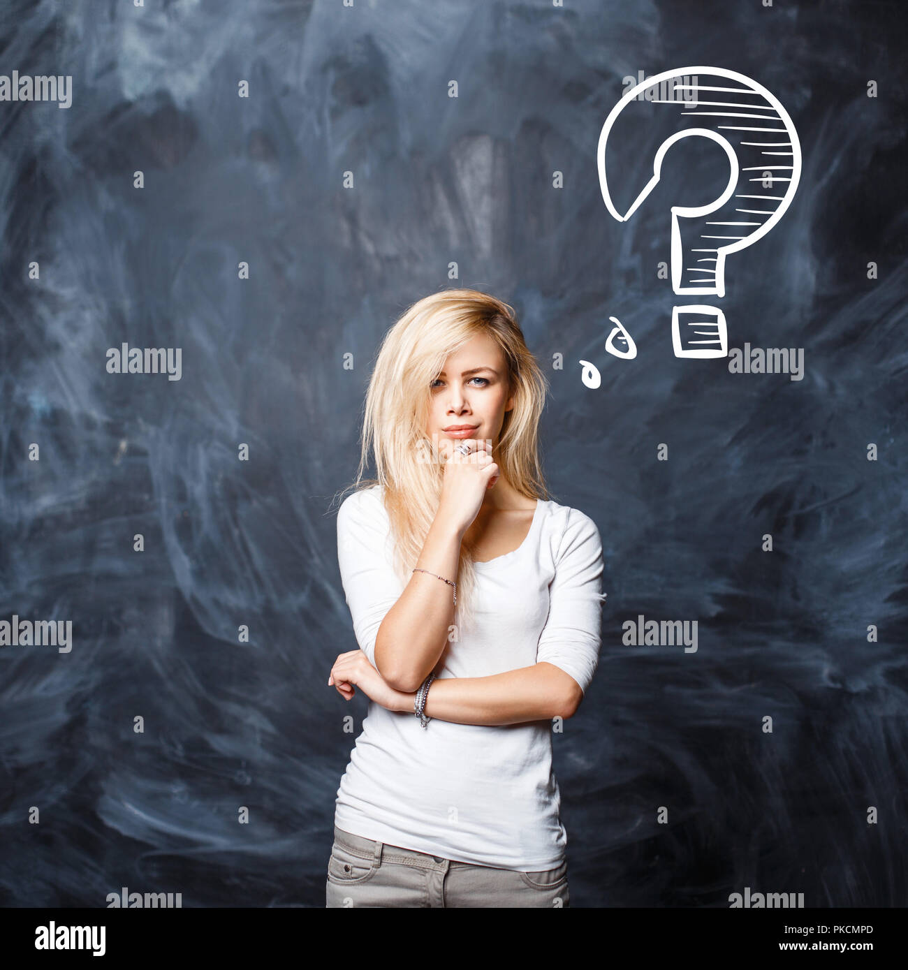 Beautiful blonde Woman with question mark on blackboard Stock Photo - Alamy