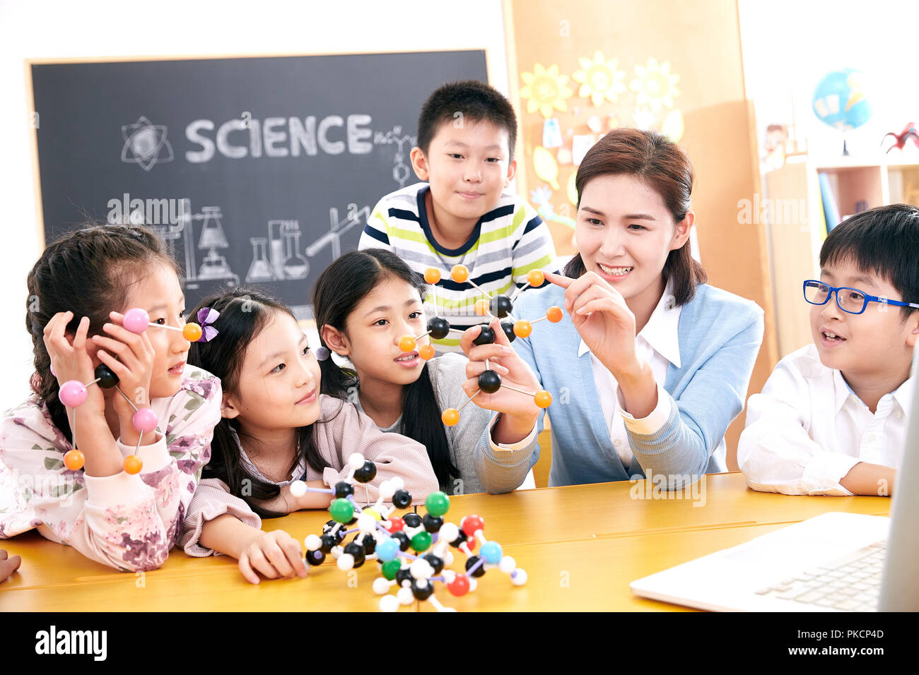 Female teachers and students use computers in the classroom Stock Photo ...