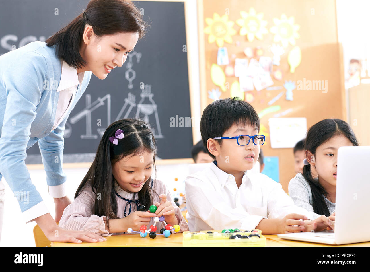 Female teachers and students use computers in the classroom Stock Photo ...