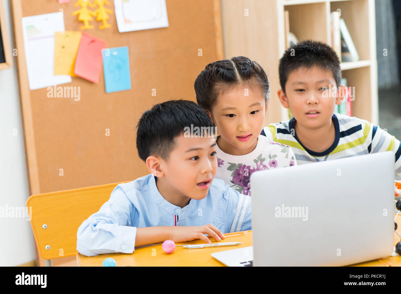 Asian elementary schoolgirl studying in hi-res stock photography and ...