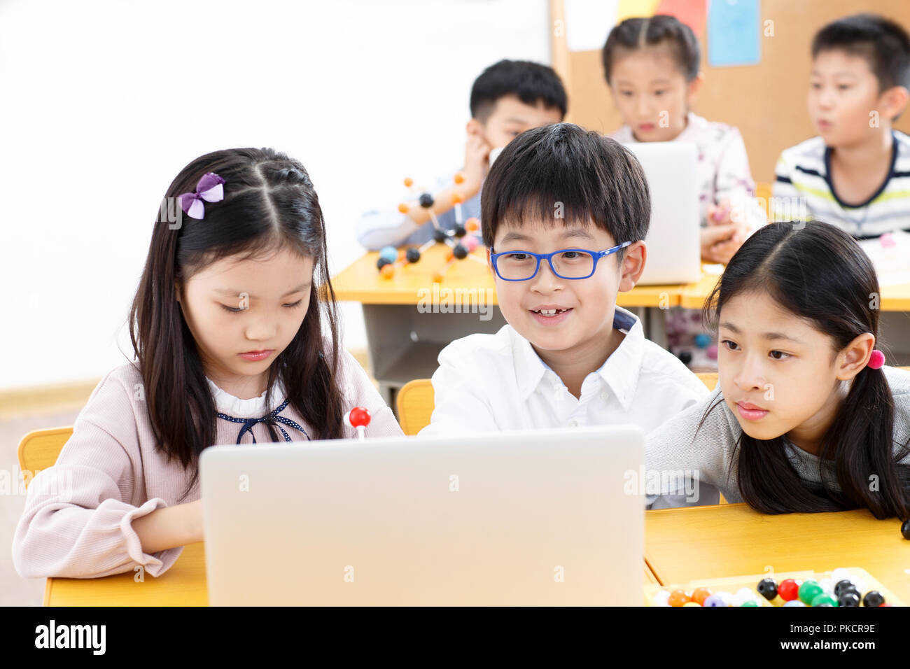 Elementary school students use computers in the classroom Stock Photo ...