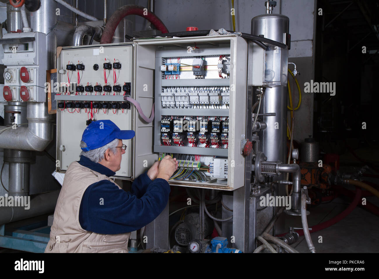 electrician at work with an electric panel Stock Photo - Alamy