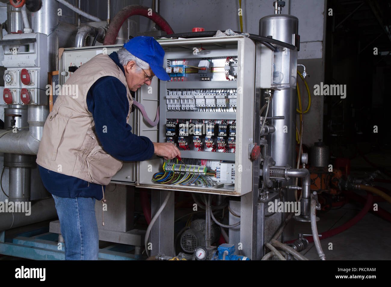 electrician at work with an electric panel Stock Photo - Alamy