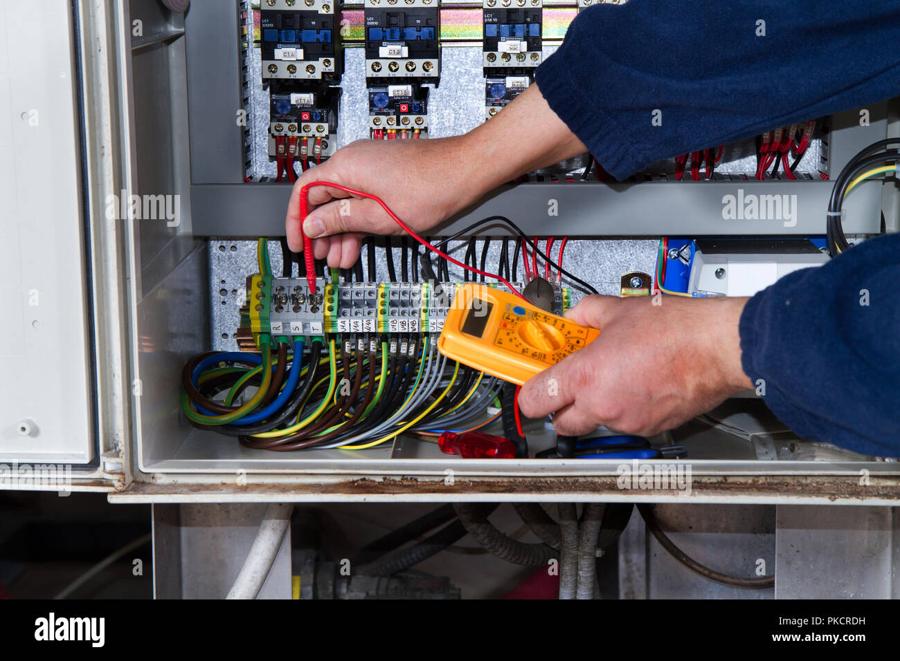 electrician at work with an electric panel Stock Photo - Alamy