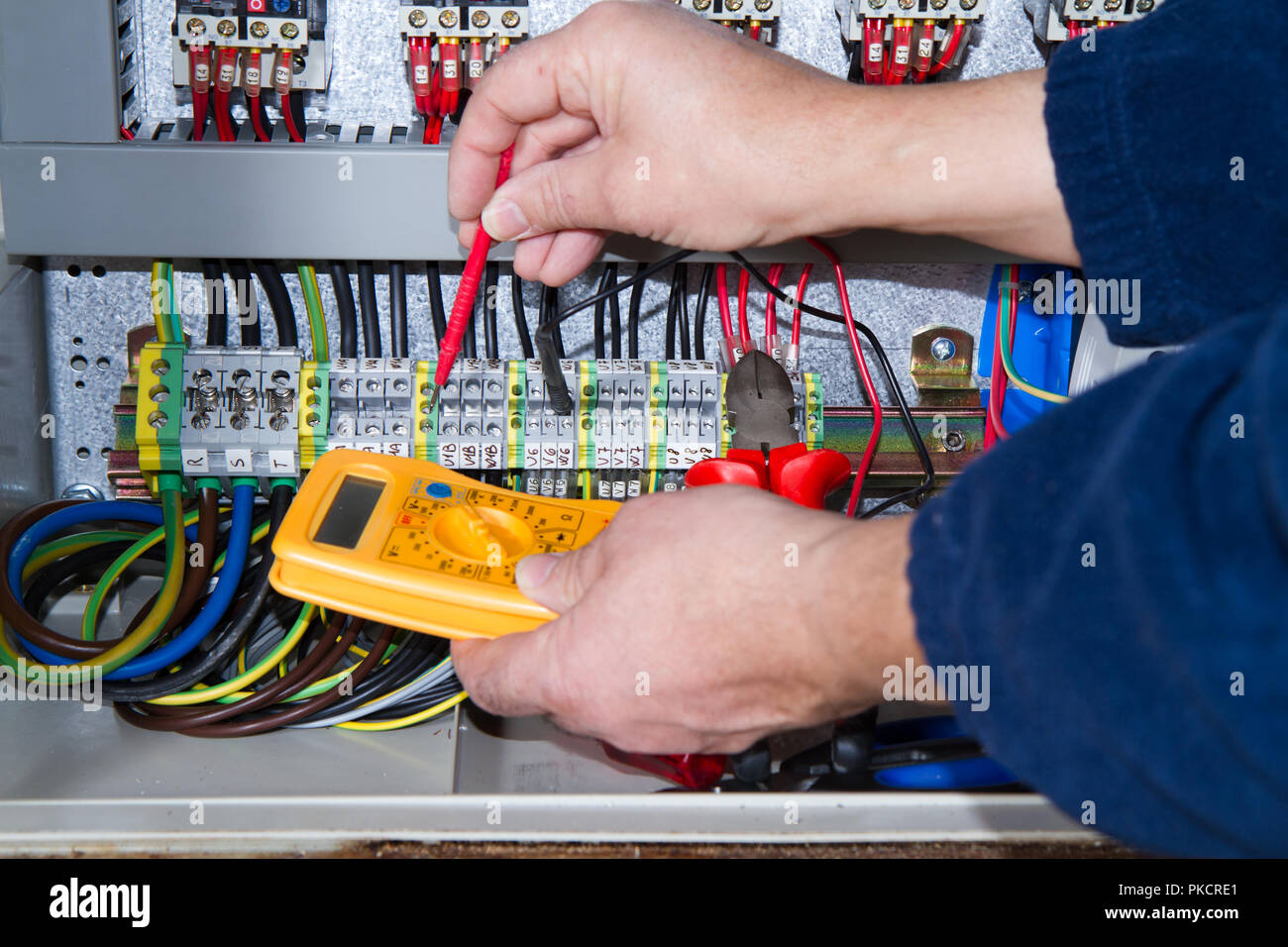 electrician at work with an electric panel Stock Photo - Alamy