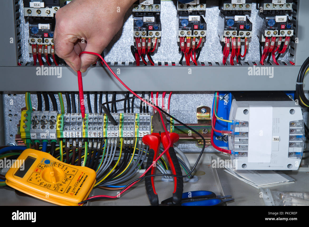electrician at work with an electric panel Stock Photo - Alamy