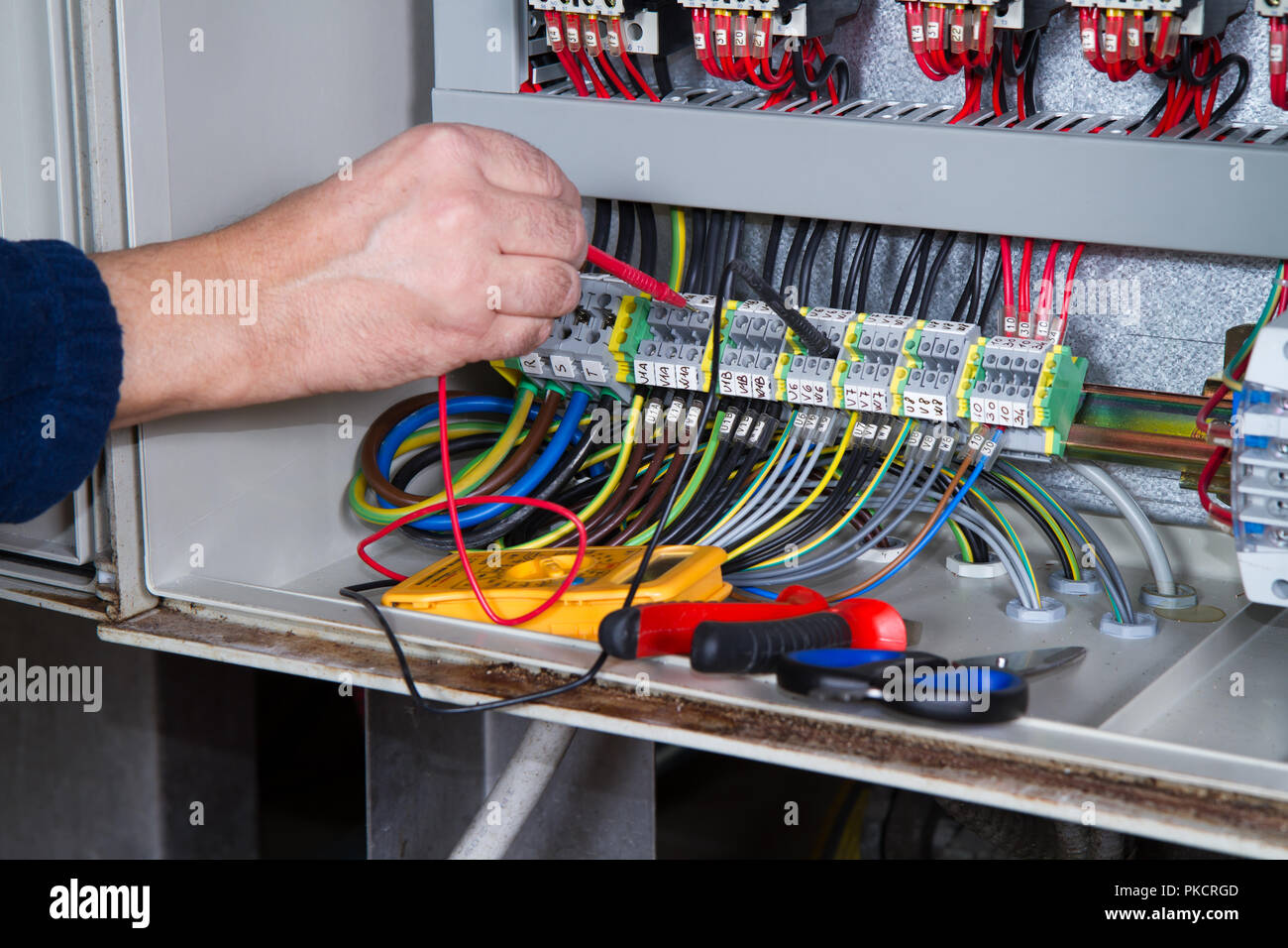 electrician at work with an electric panel Stock Photo - Alamy