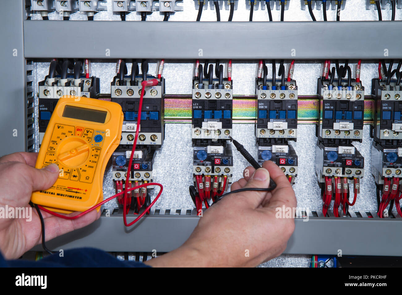 electrician at work with an electric panel Stock Photo - Alamy