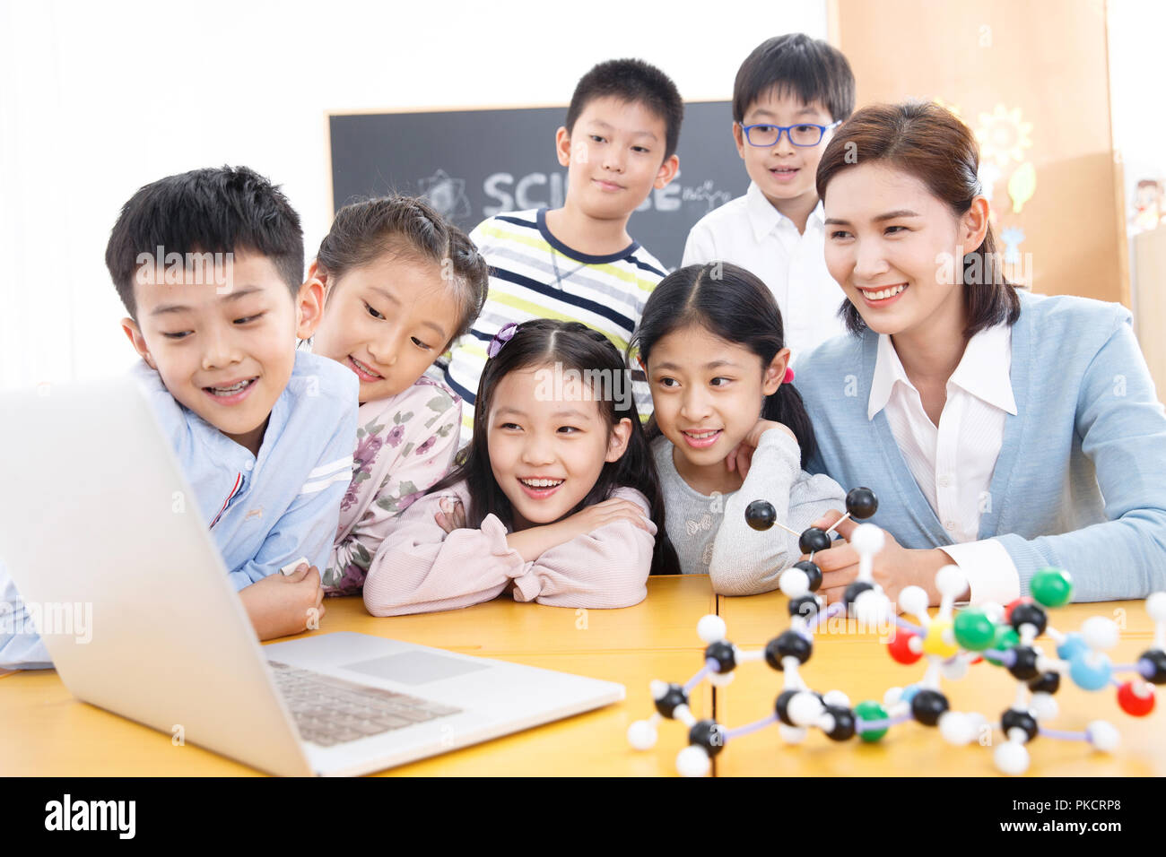 Female teachers and students use computers in the classroom Stock Photo ...