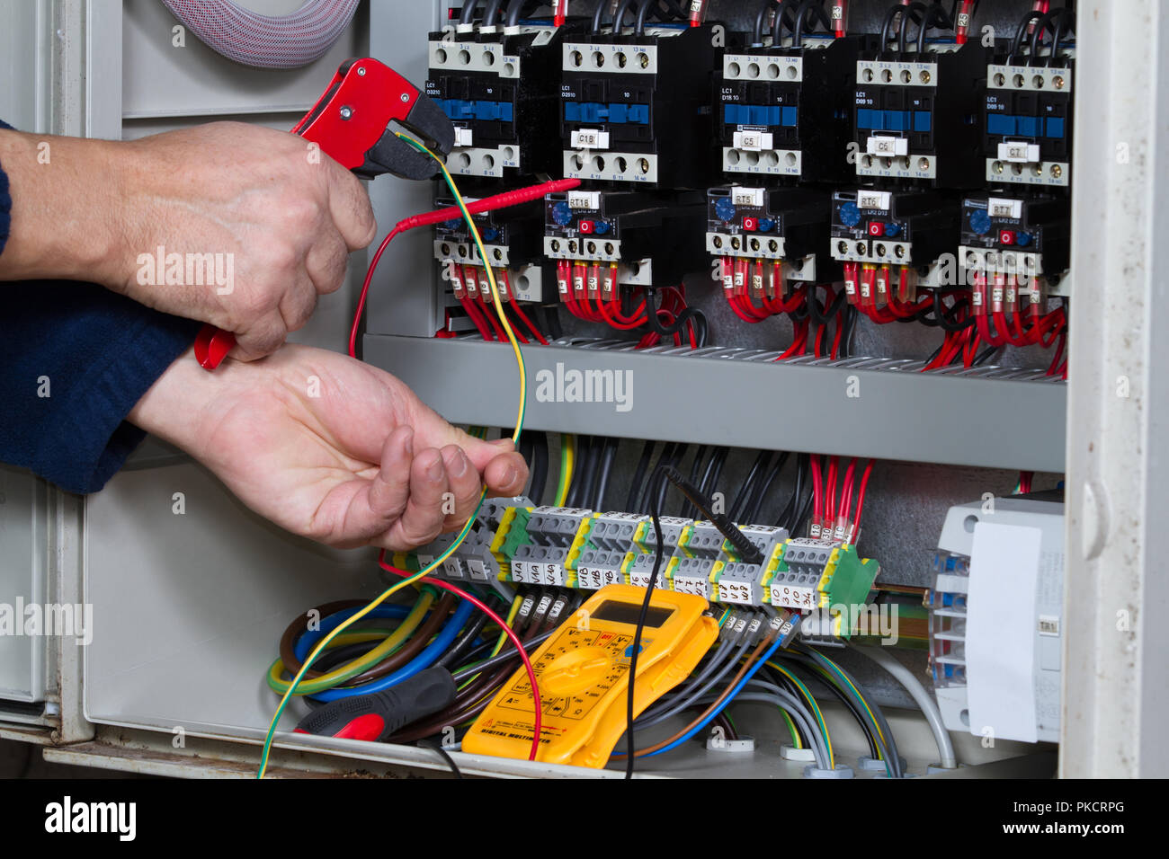 electrician at work with an electric panel Stock Photo - Alamy
